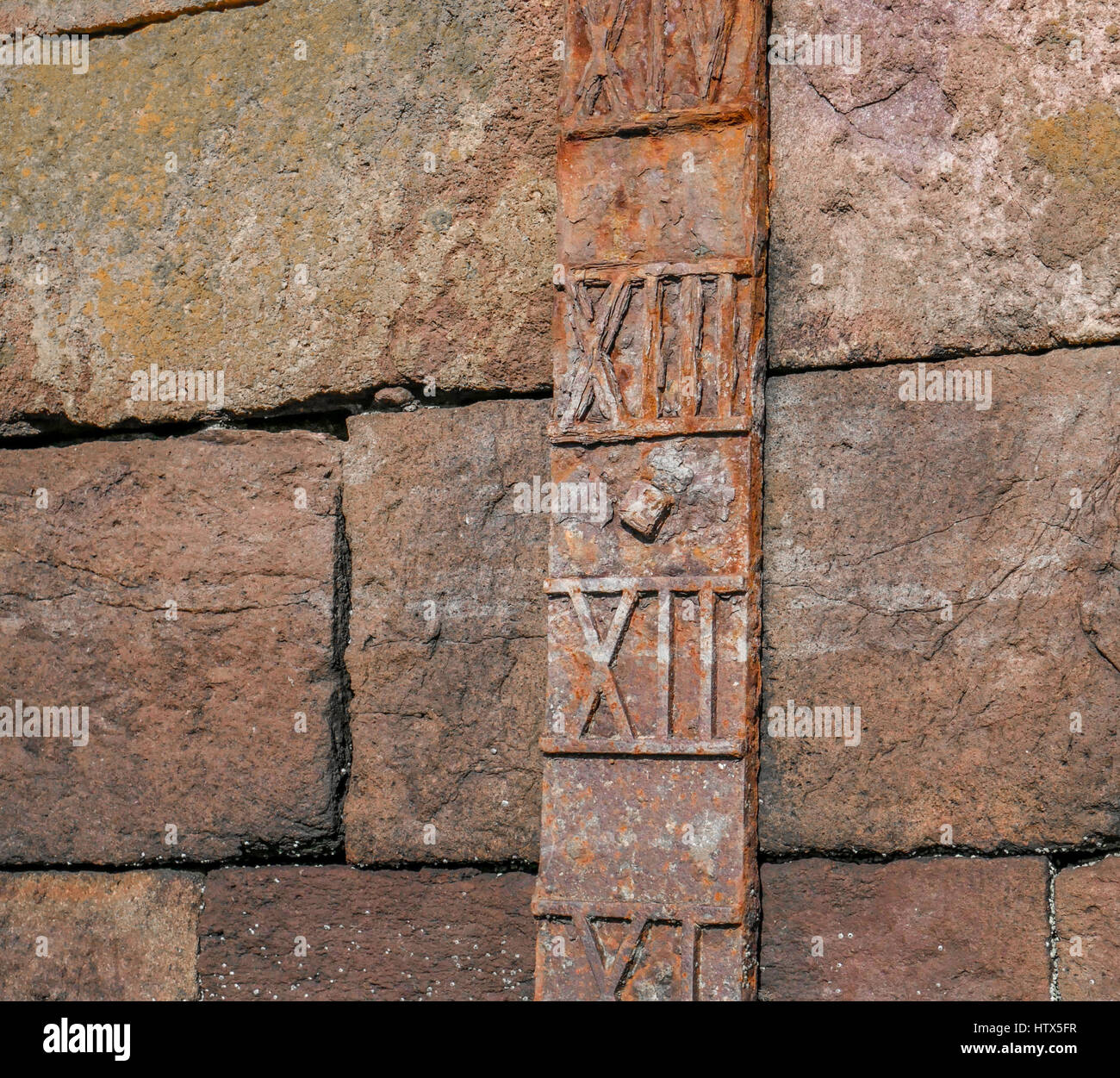 Old rusty water level tide marker in harbour wall, North Berwick, East ...