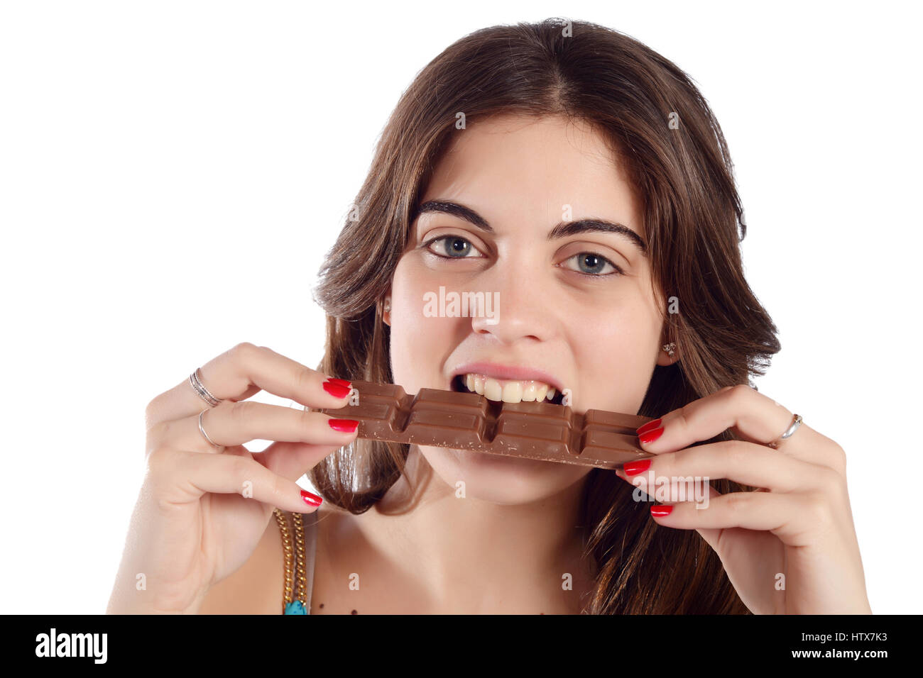Close up of a young beautiful woman eating chocolate. Isolated white ...