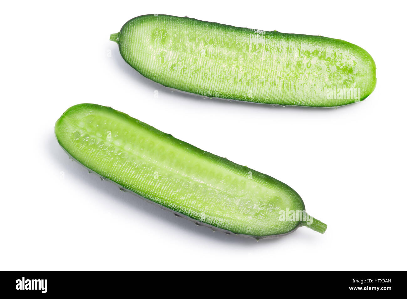 Fresh halved cucumber (Cucumis sativus), top view. Clipping paths ...