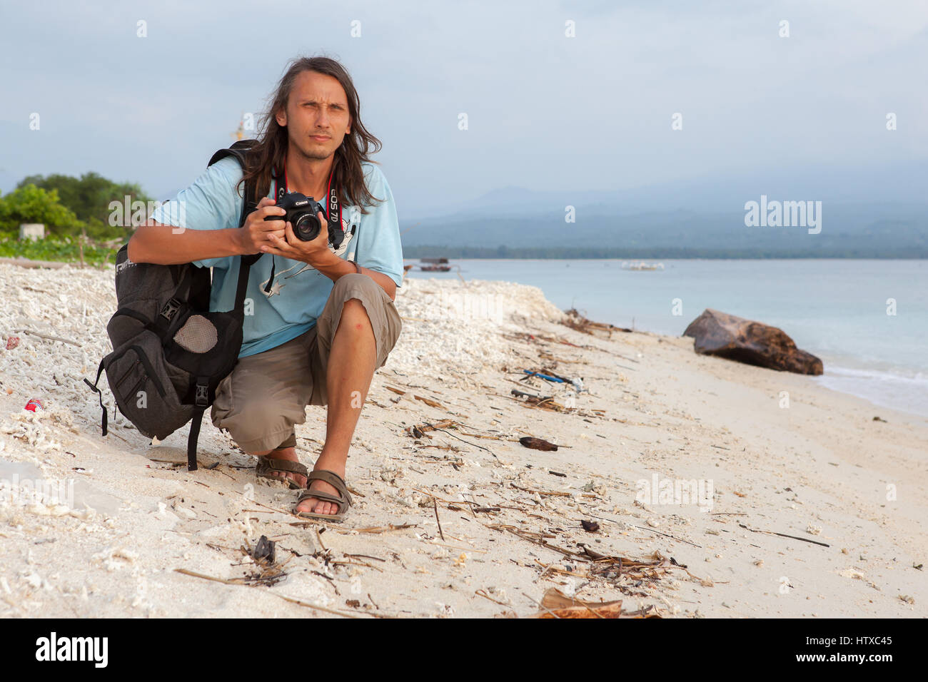 Traveler photographer take pictures on the sandy beach Stock Photo - Alamy