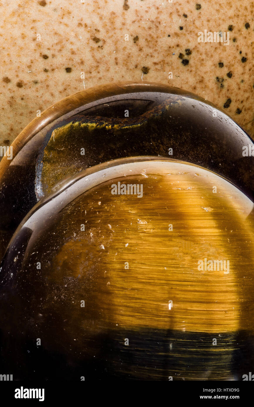 Abstract Macro of two shining stone balls in soft with brown background ...