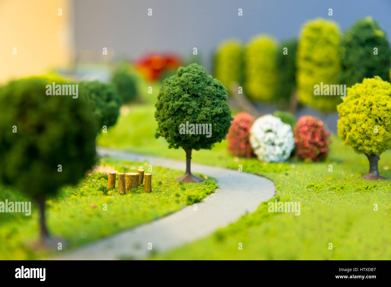 miniature landscape of a park with trees a small road and grass ...