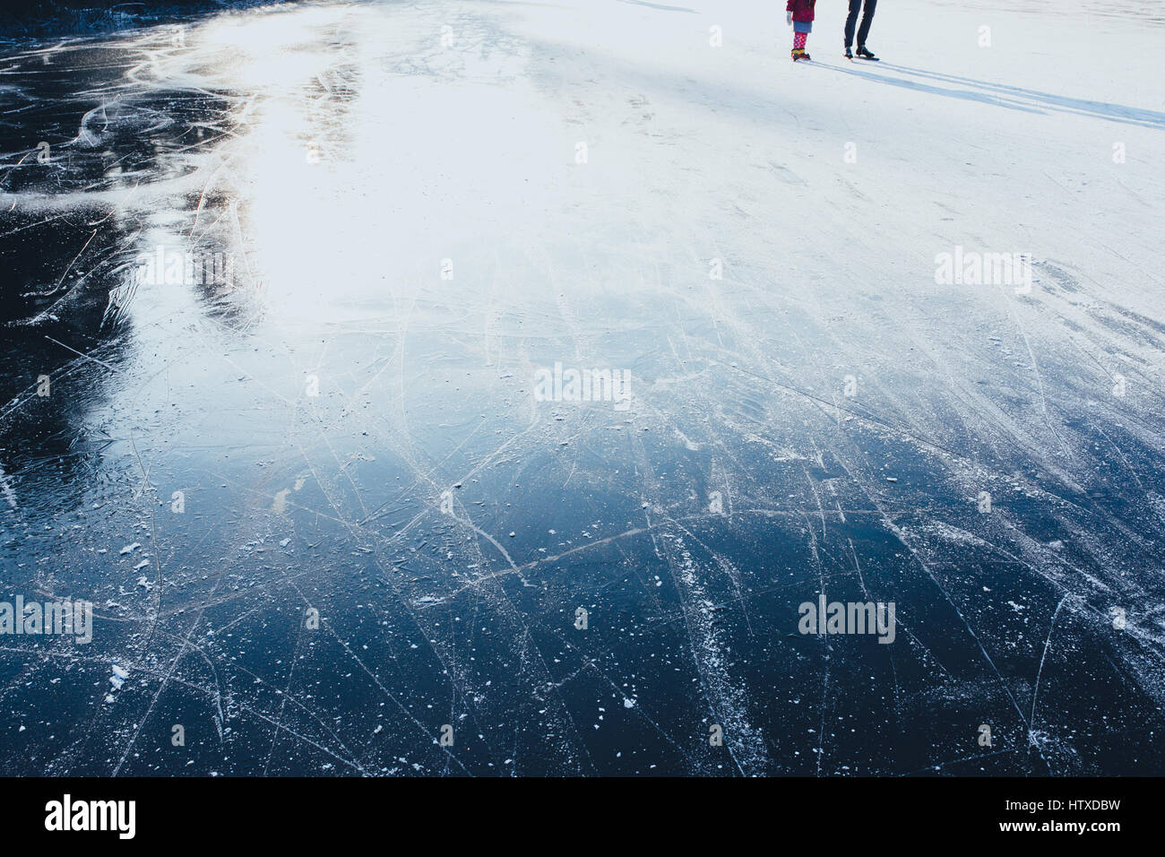 Surface of outdoor ice with skaters, replete with skate marks. Ice ...