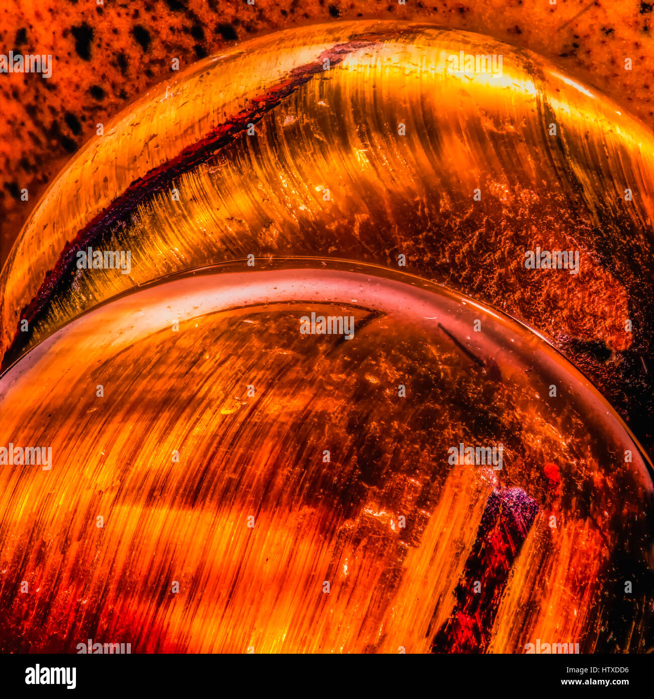 two shining vibrant red orange stone balls macro,red black background ...