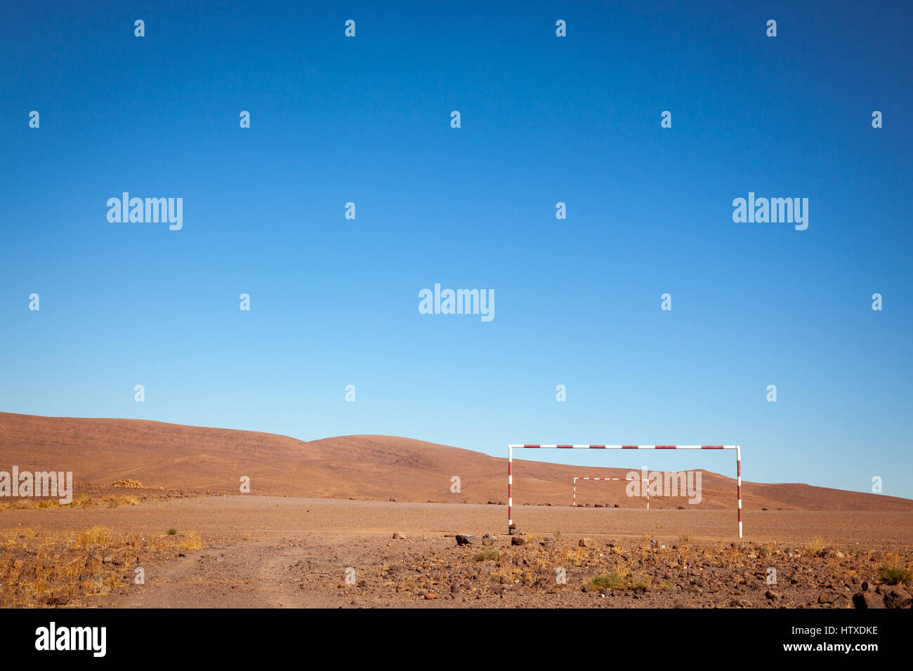 Empty soccer field with goals in desert africa Stock Photo - Alamy
