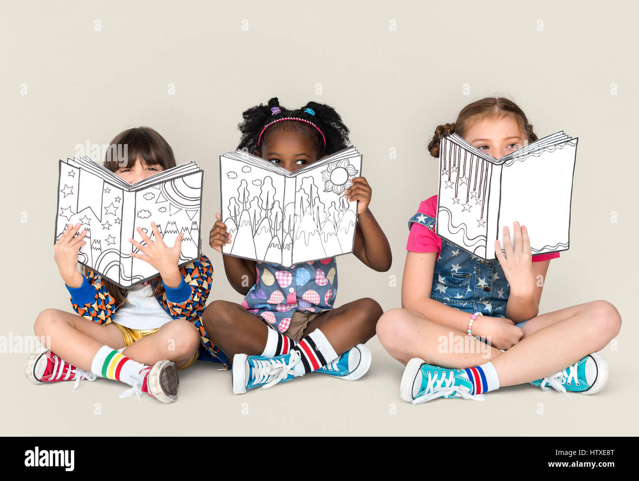 Little Children Reading Sitting Down Stock Photo - Alamy