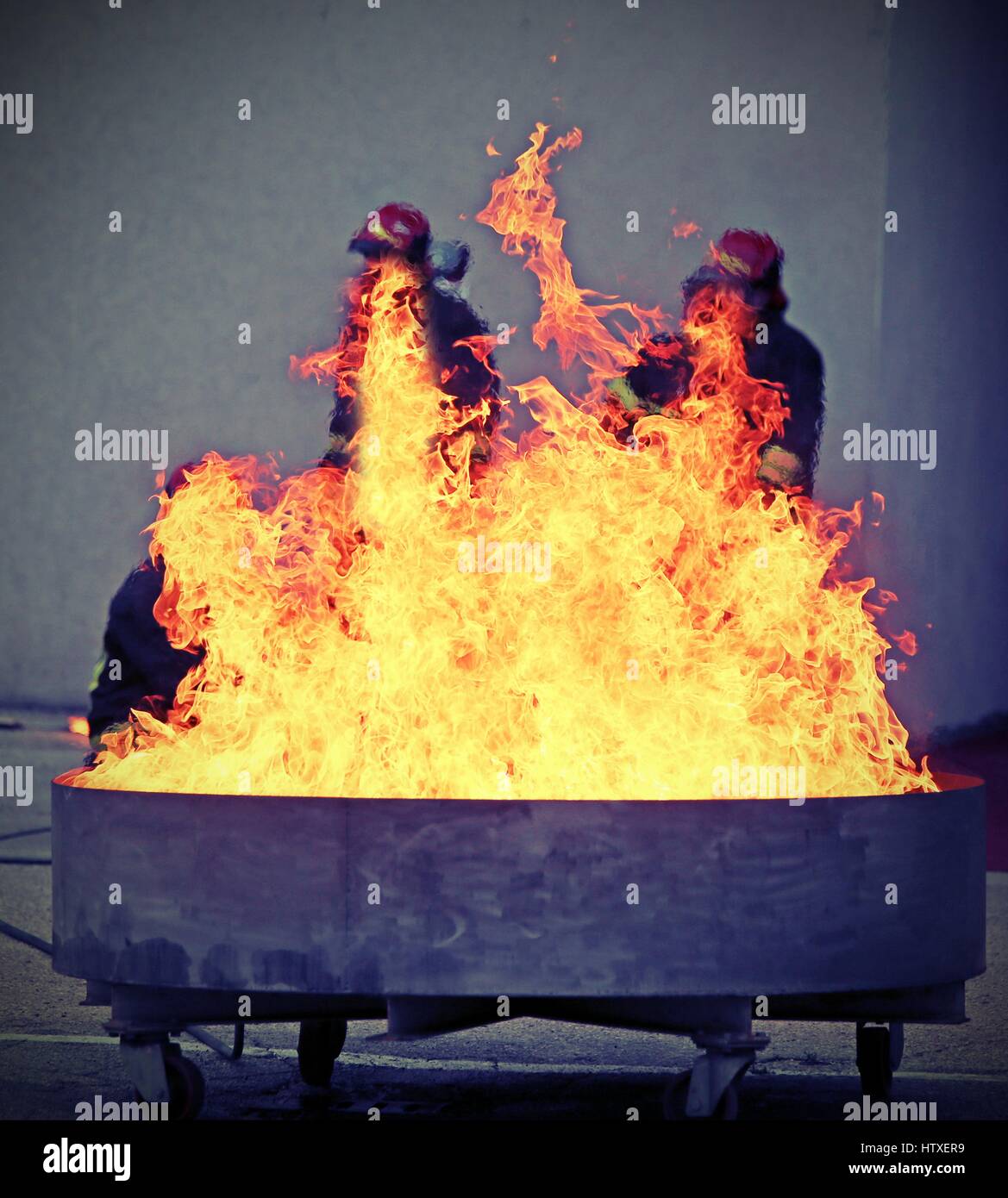 firefighters during the test of a fire extinguishing caused by a liquid ...