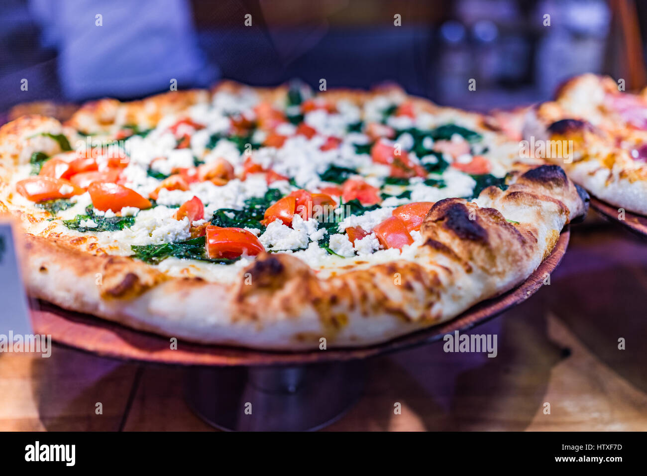 Feta cheese pizza macro closeup with tomatoes and spinach Stock Photo ...