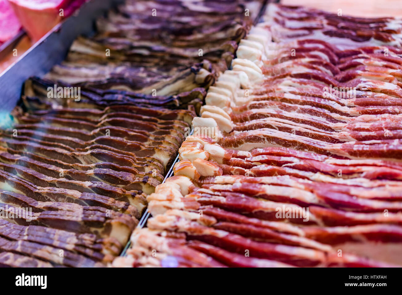 Display of many thick bacon pieces at butcher shop Stock Photo - Alamy