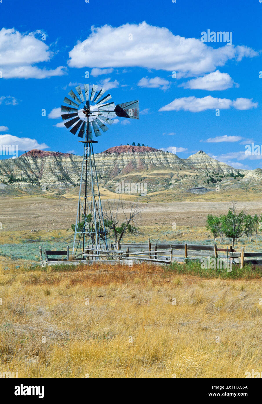 windmill below badlands in the powder river valley near mizpah, montana ...