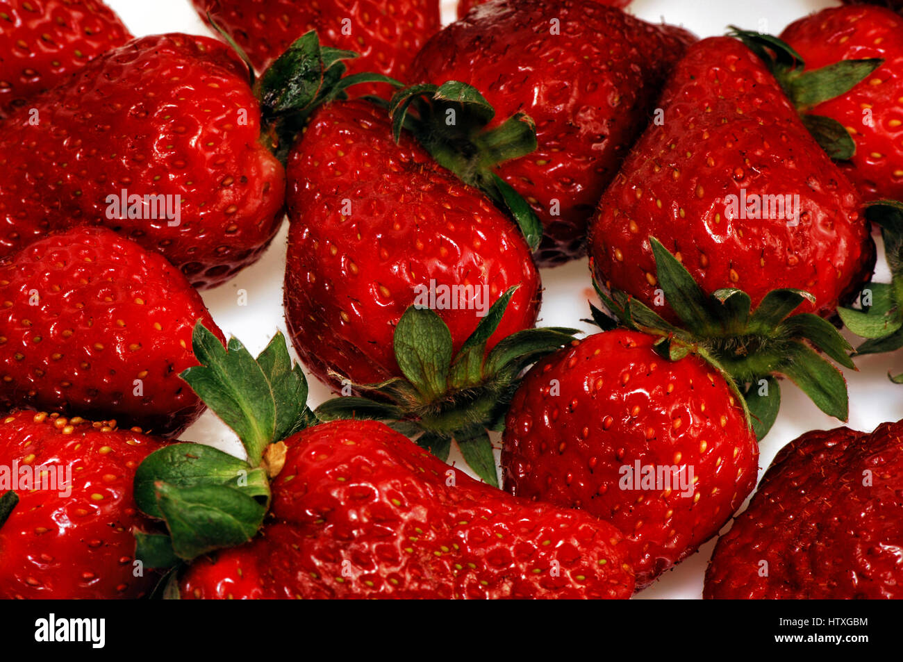 Red strawberries isolated on white Stock Photo - Alamy