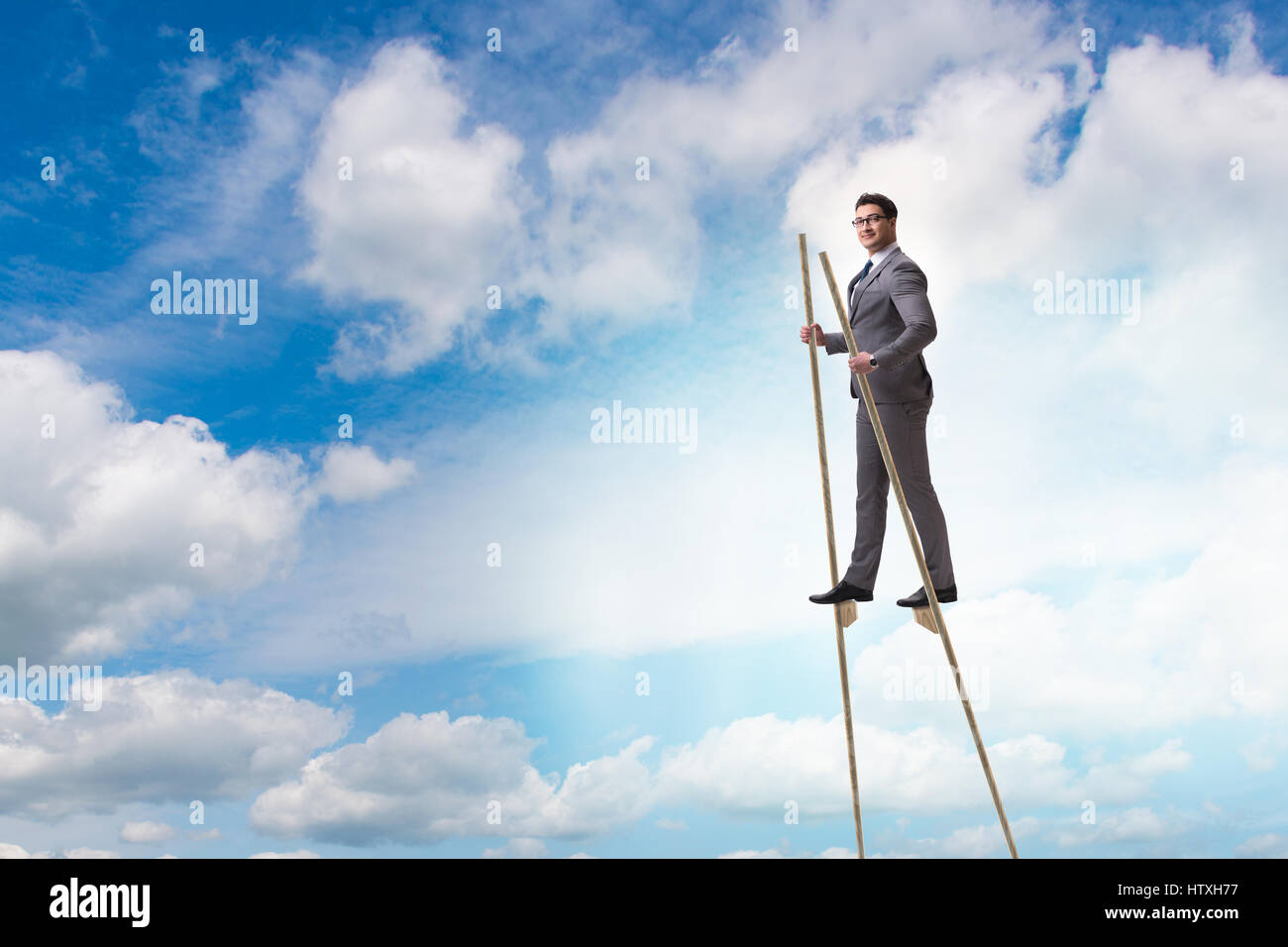 Businessman walking on stilts - standing out from the crowd Stock Photo - Alamy