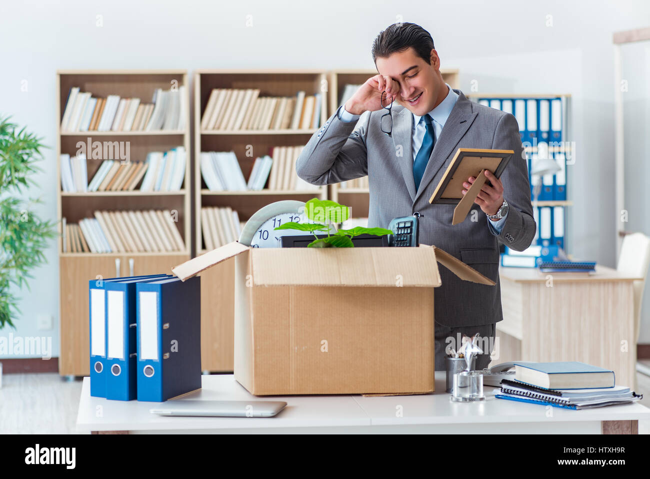 Man moving office with box and his belongings Stock Photo - Alamy