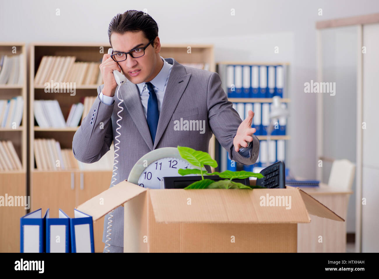 Man moving office with box and his belongings Stock Photo - Alamy