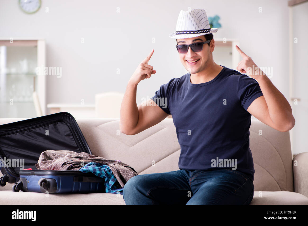 Man going on vacation packing his suitcase Stock Photo - Alamy