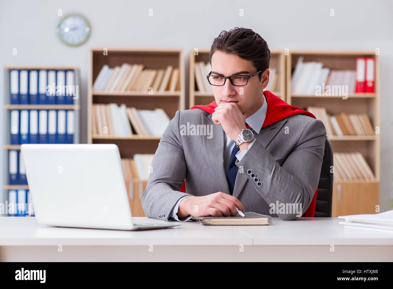 Superhero businessman working in the office Stock Photo - Alamy