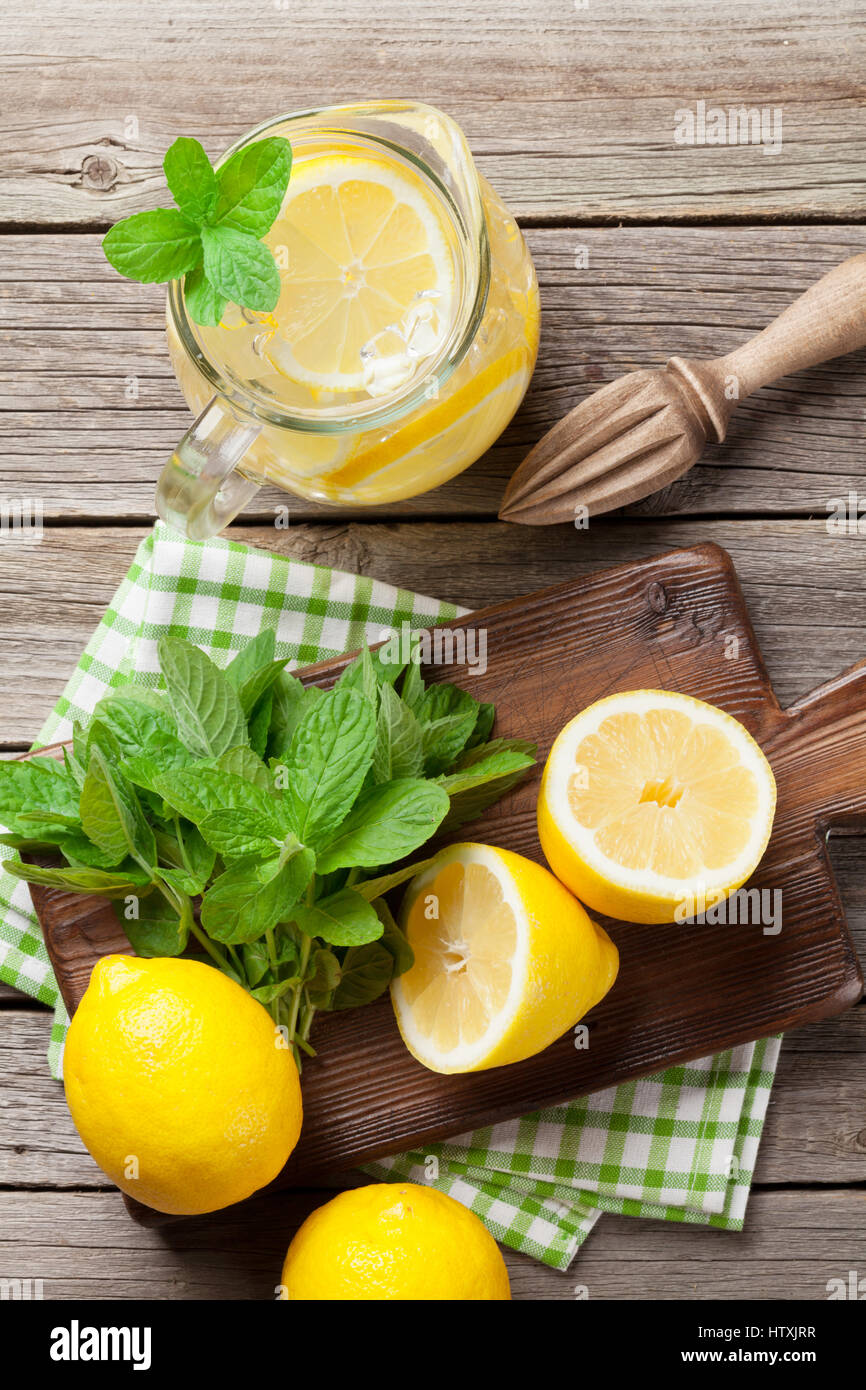 Lemonade with lemon, mint and ice on wooden table. Top view Stock Photo ...