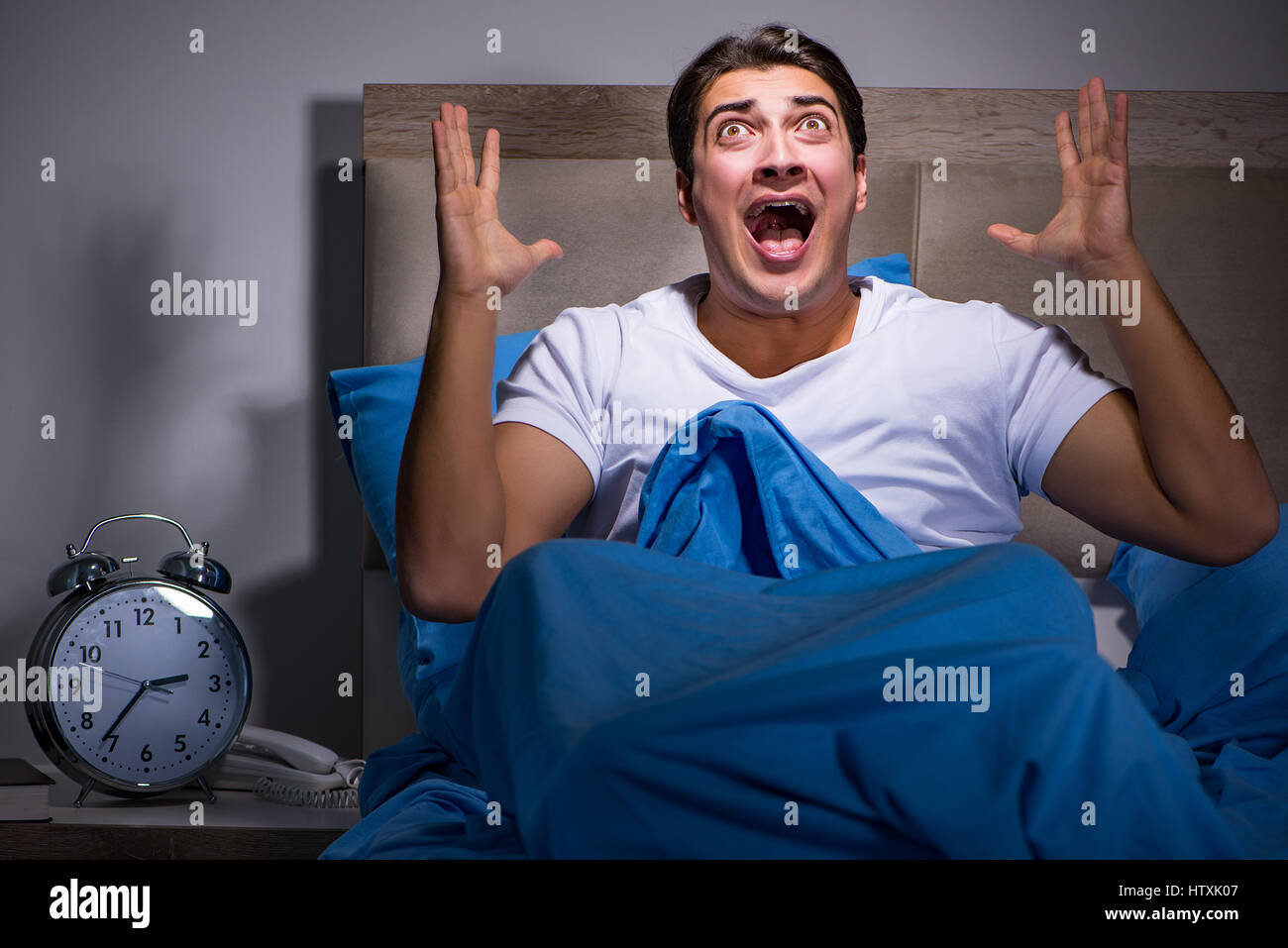 Young man scared in bed Stock Photo - Alamy