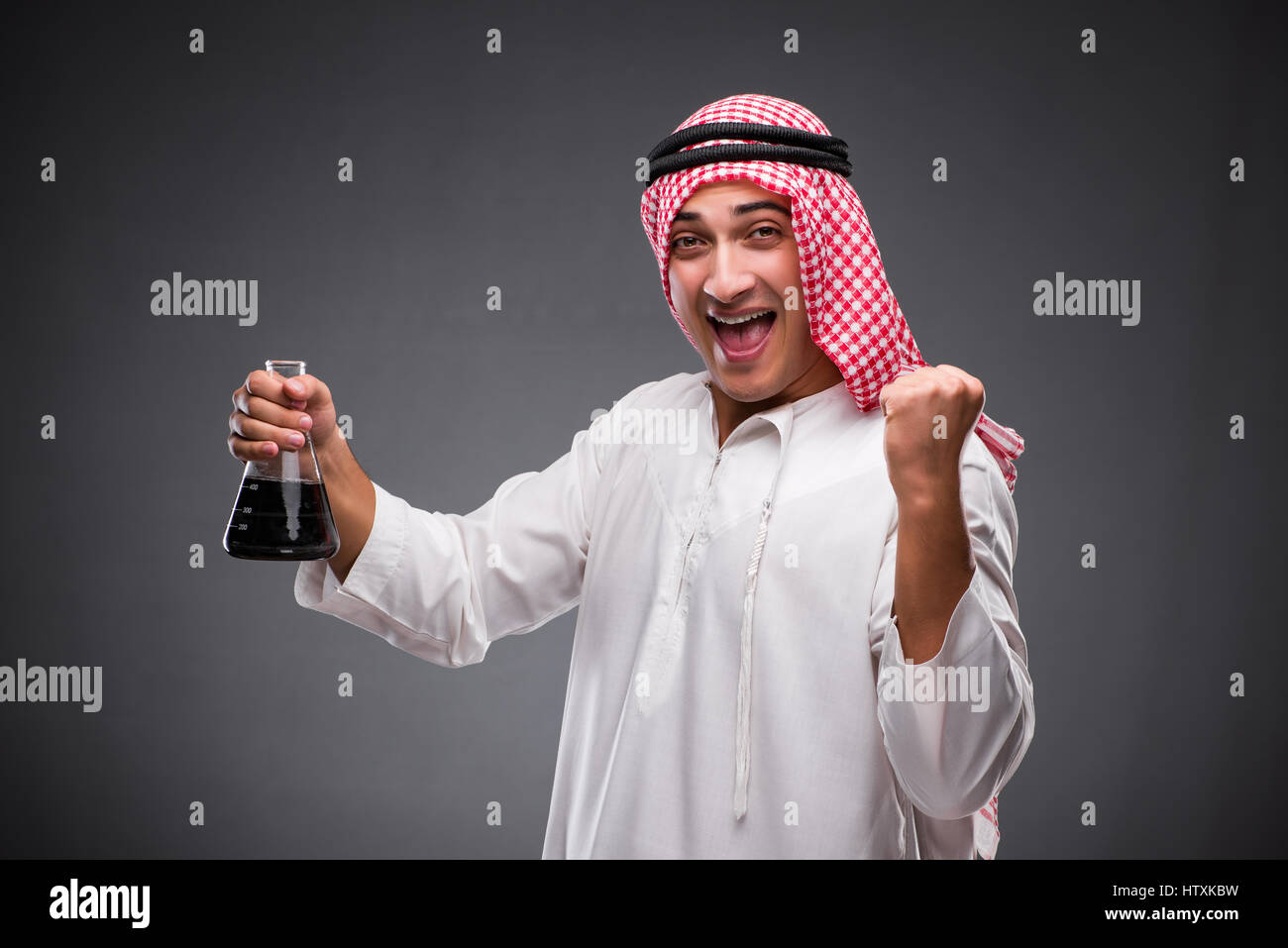 Arab with oil on gray background Stock Photo - Alamy