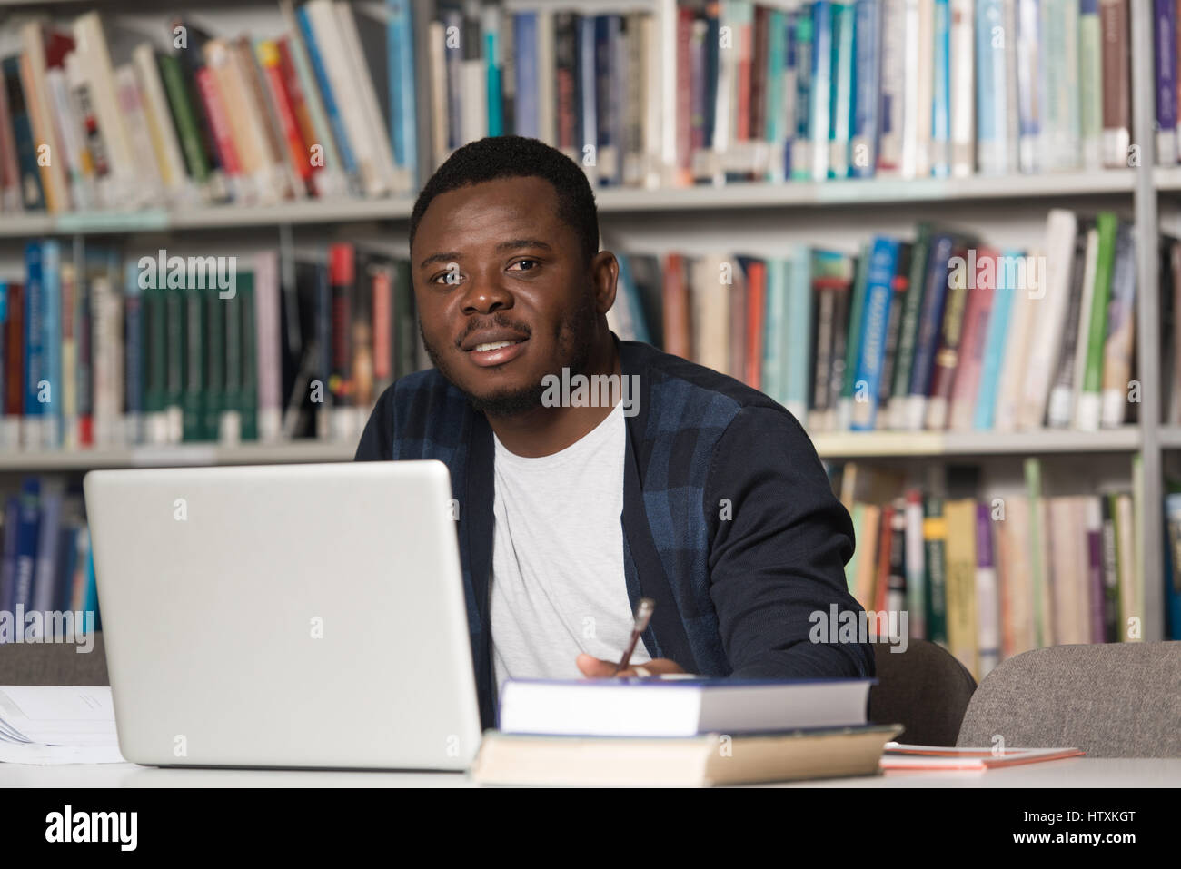Portrait Of African Clever Student With Open Book Reading It In College ...