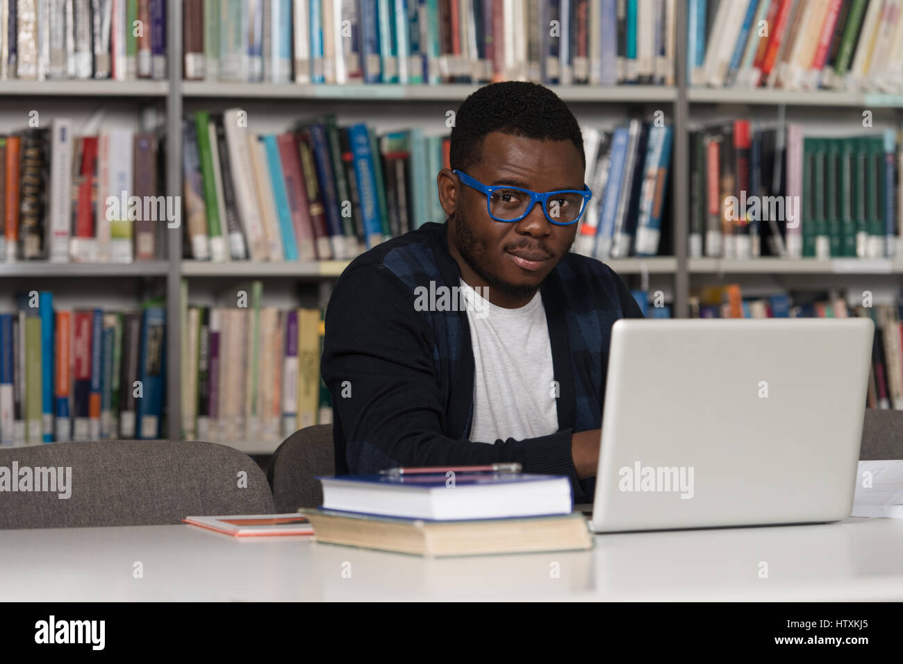 Portrait Of African Clever Student With Open Book Reading It In College ...