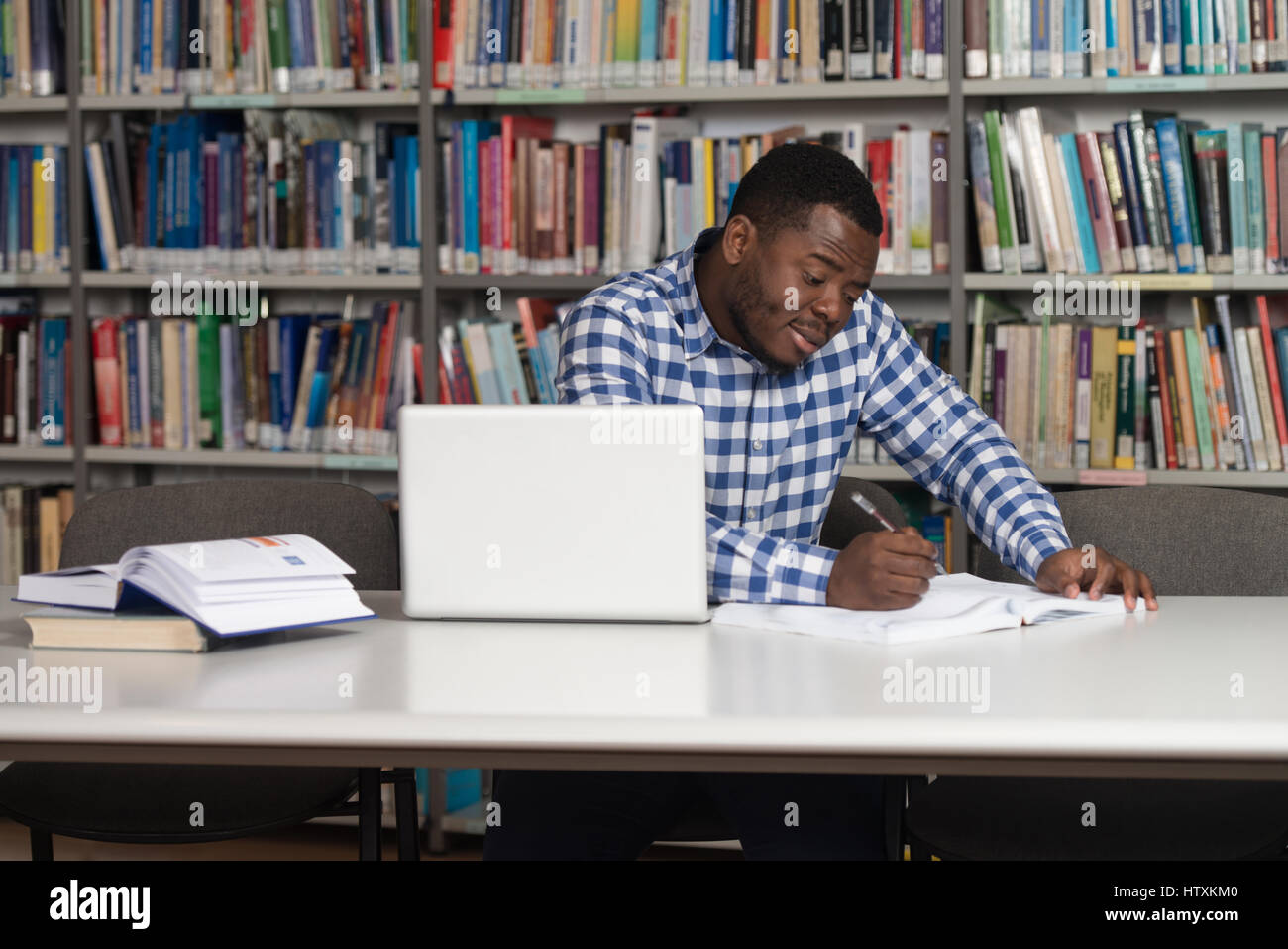 Portrait Of African Clever Student With Open Book Reading It In College ...