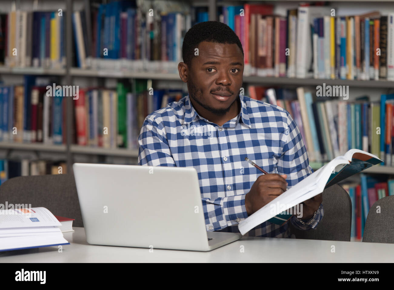 Portrait Of African Clever Student With Open Book Reading It In College ...
