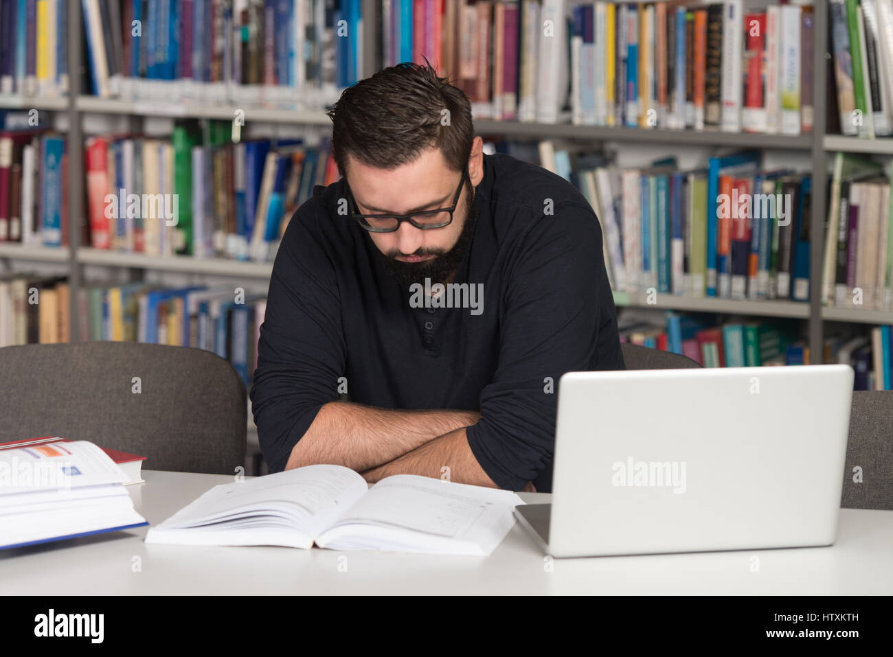 In The Library - Handsome Male Student With Laptop And Books Working In ...