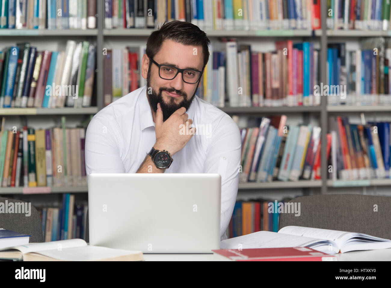 In The Library - Handsome Male Student With Laptop And Books Working In ...