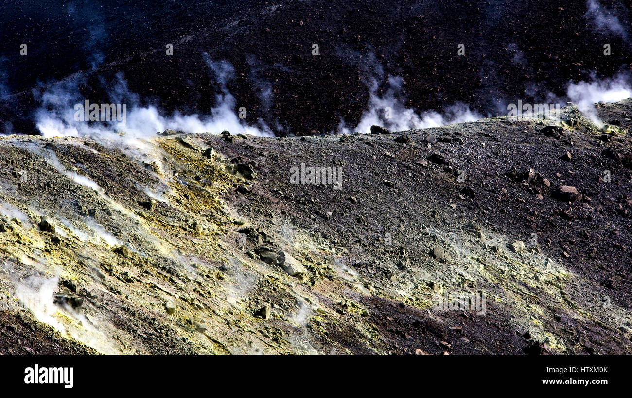 Sulfur haze and crystals on the rocks. Volcano Island in the ...