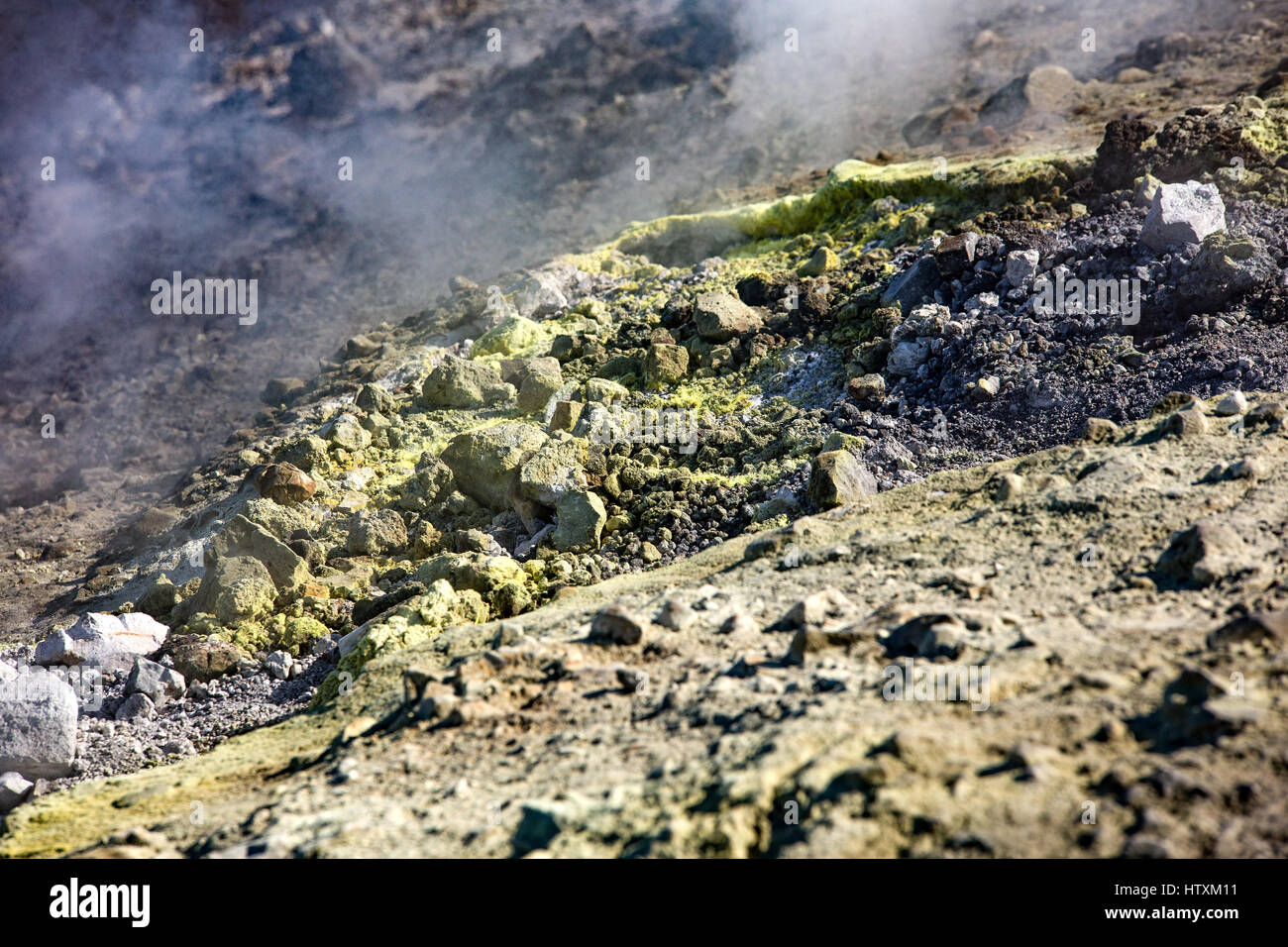 Sulfur haze and crystals on the rocks. Volcano Island in the ...