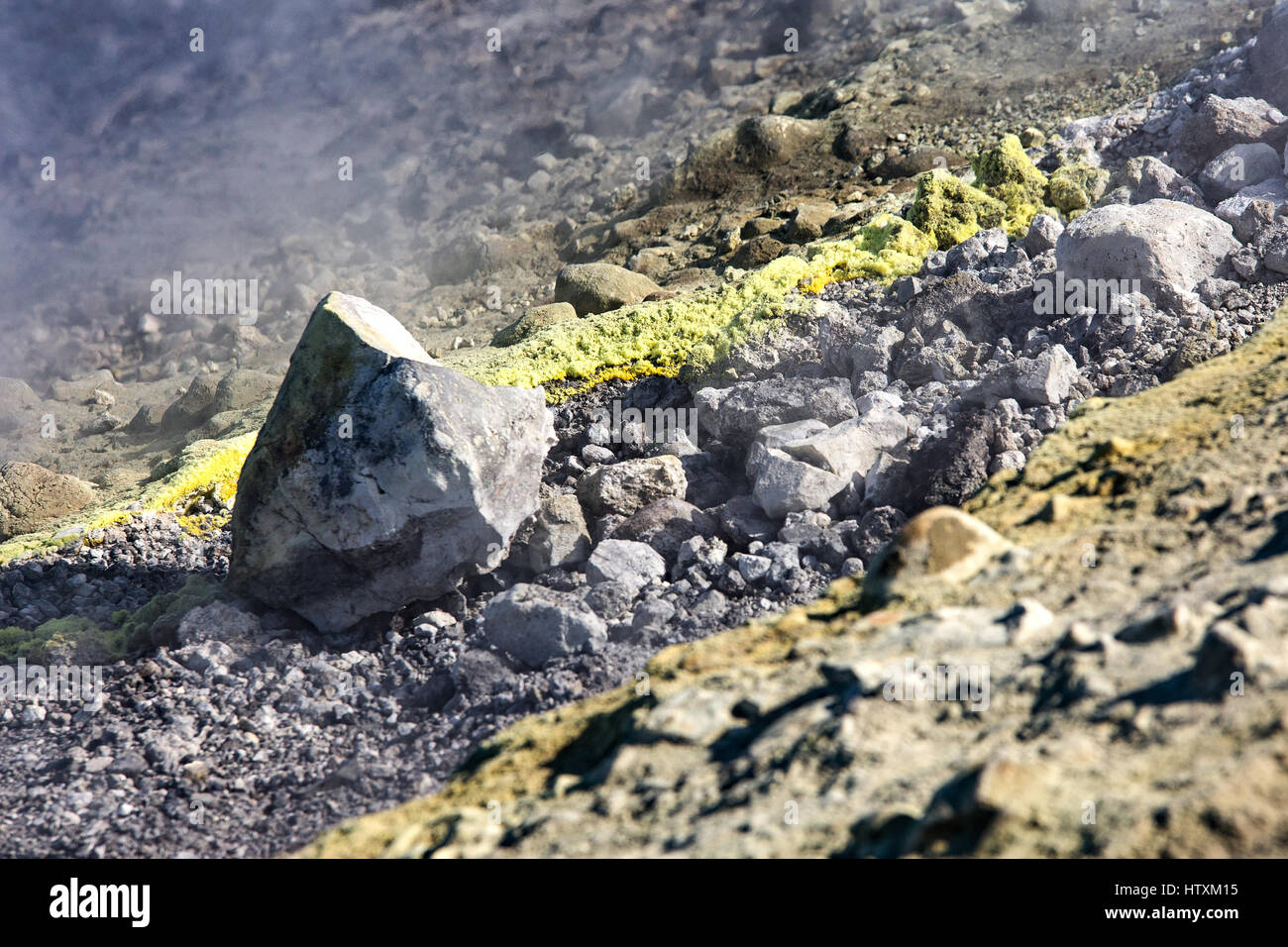 Sulfur haze and crystals on the rocks. Volcano Island in the ...