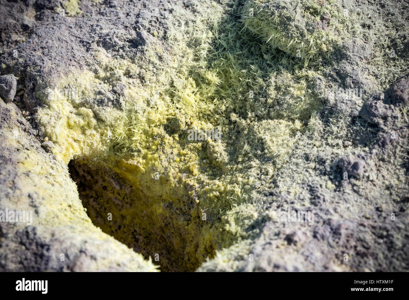 Sulfur haze and crystals on the rocks. Volcano Island in the ...