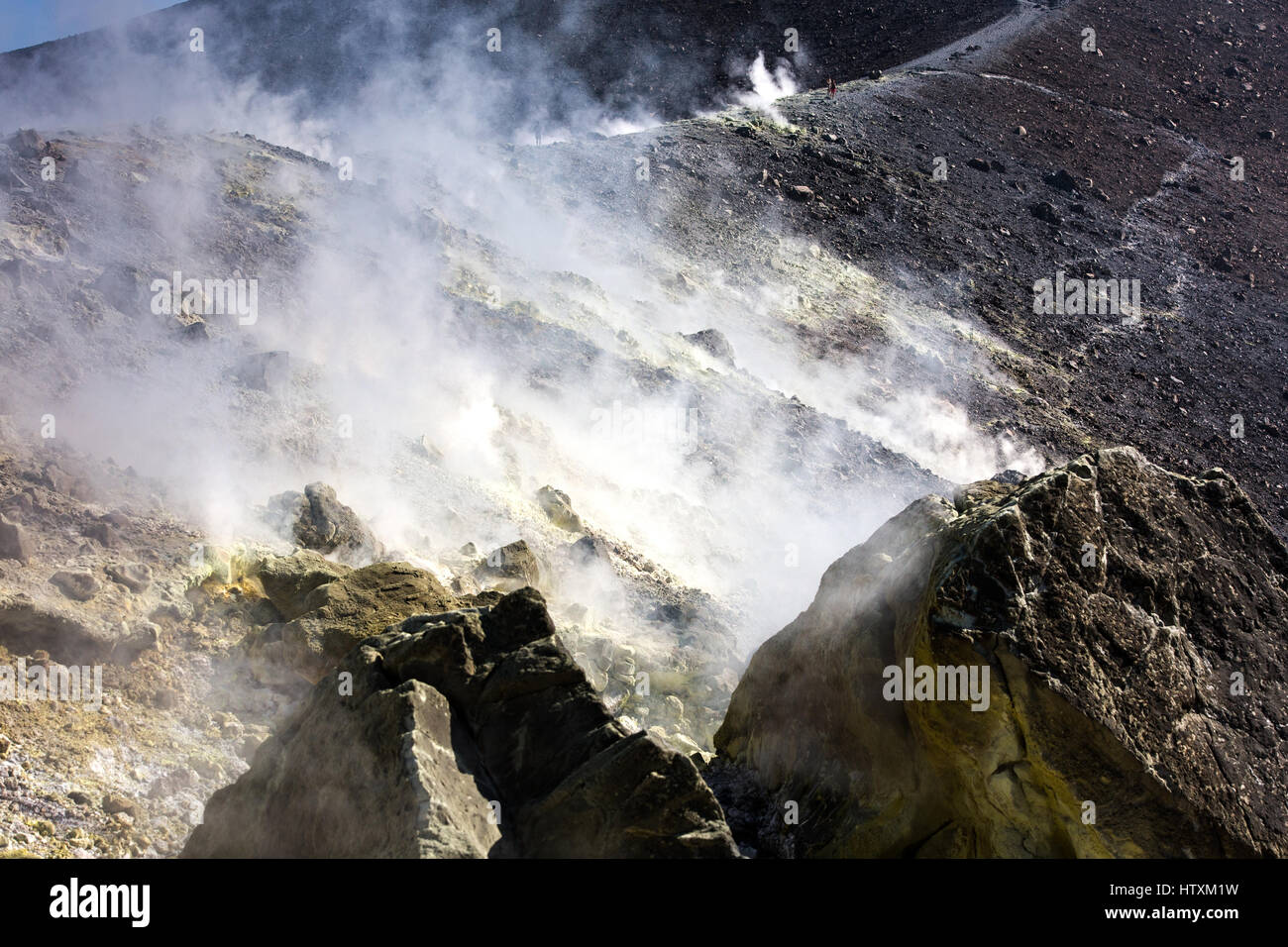 Sulfur haze and crystals on the rocks. Volcano Island in the ...