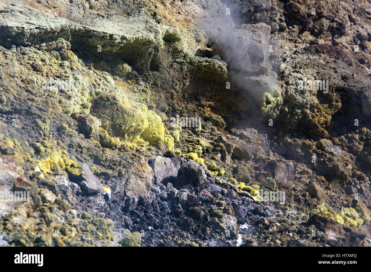 Sulfur haze and crystals on the rocks. Volcano Island in the ...