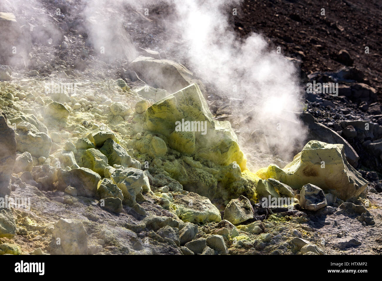 Sulfur haze and crystals on the rocks. Volcano Island in the ...