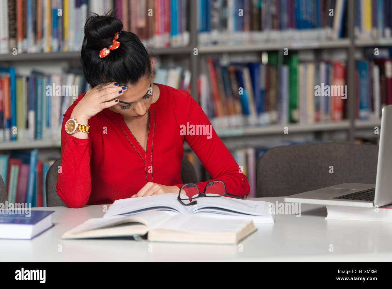 Stressed Student Of High School Sitting At The Library Desk - Shallow ...