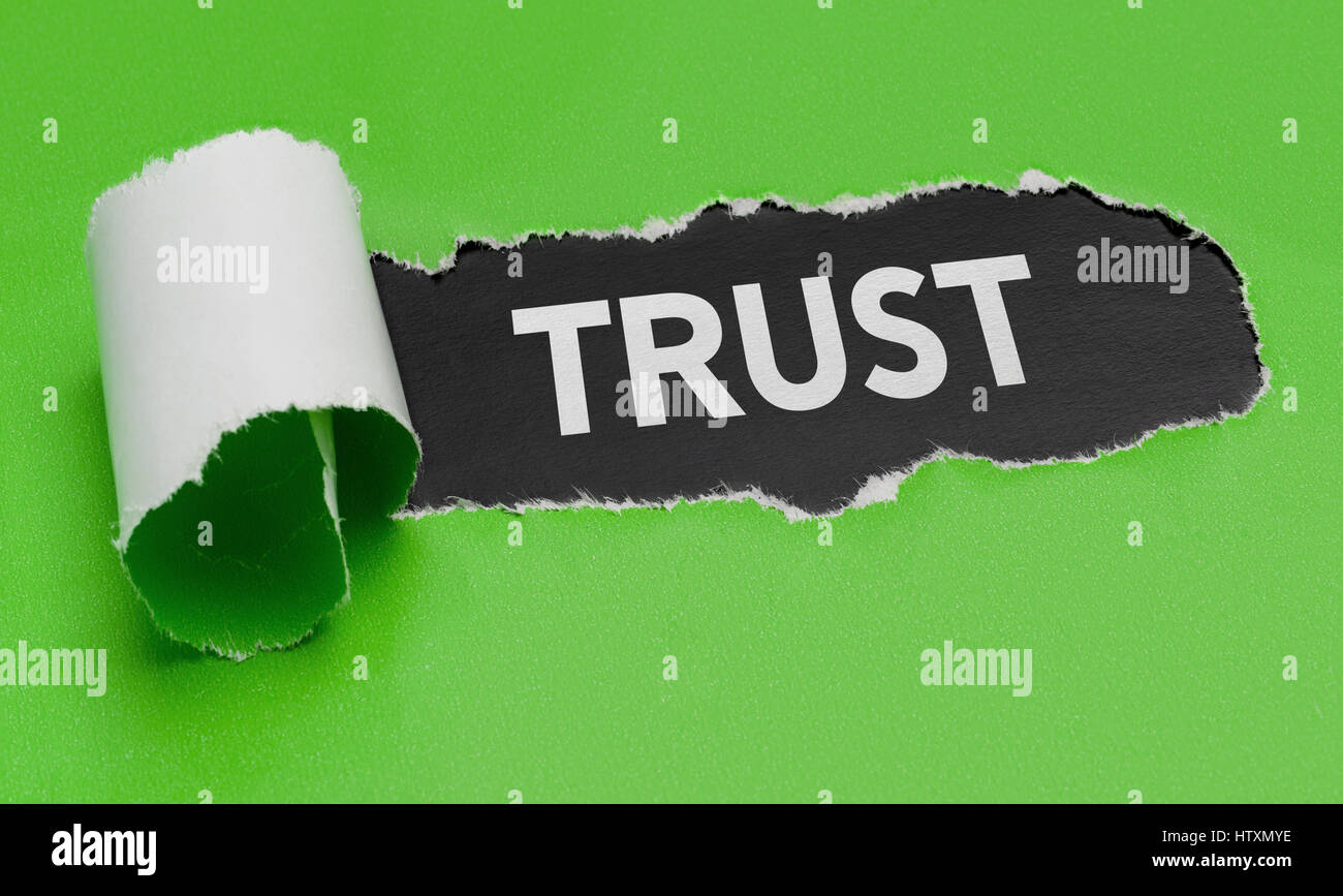 Torn green paper revealing the word Trust Stock Photo - Alamy
