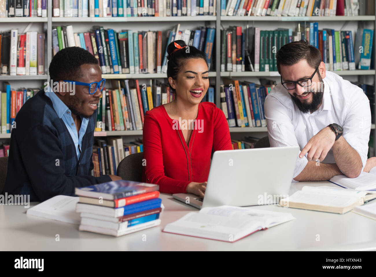 Portrait Of Clever Students With Open Book Reading It In College ...