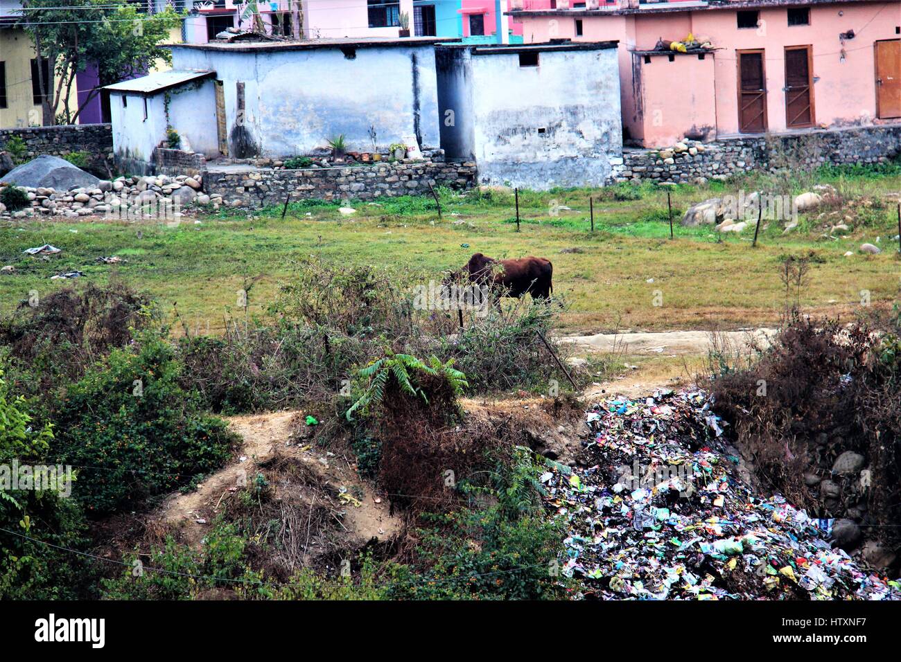 Solid garbage dump near house in hills Stock Photo - Alamy