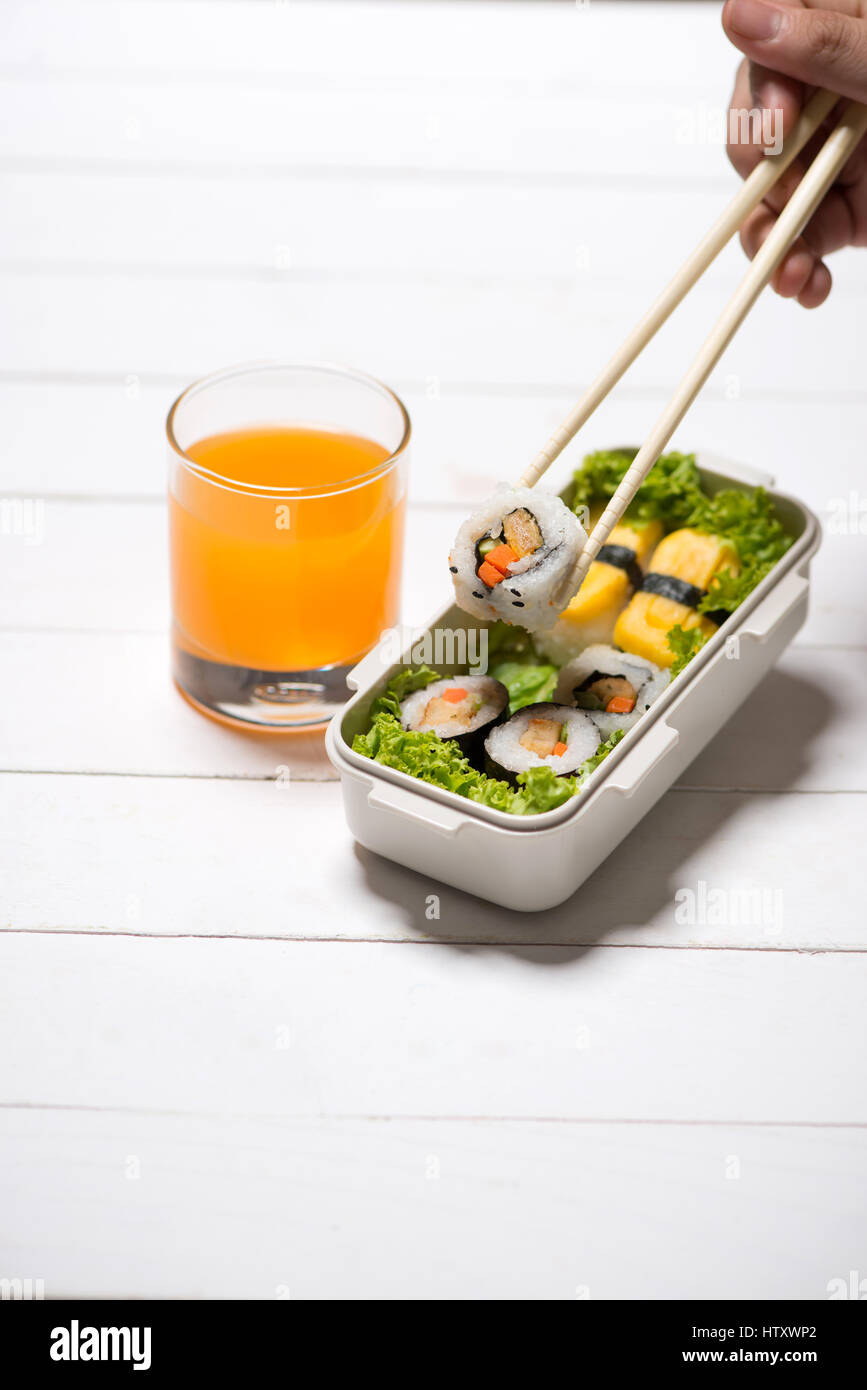 Orange juice and bento box with different food, fresh veggies and ...