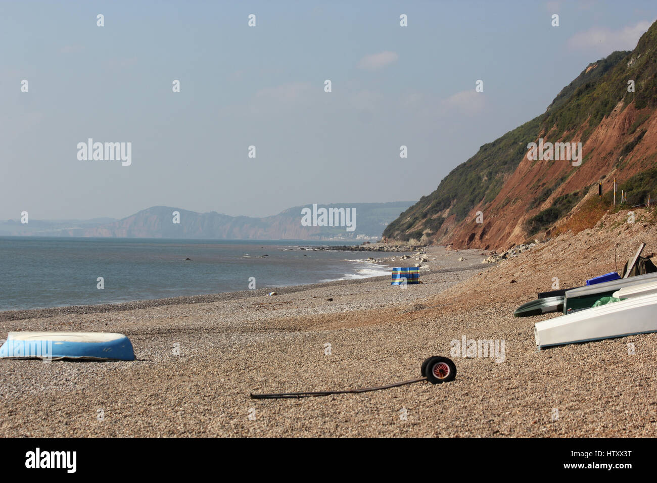 Small boats, a boat trailer and a blue and yellow windbreak on ...