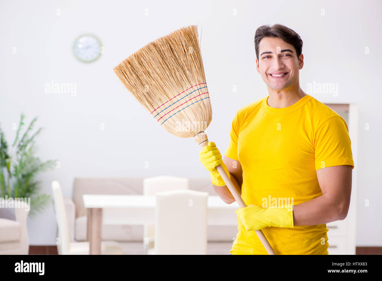 Man husband cleaning the house helping his wife Stock Photo - Alamy