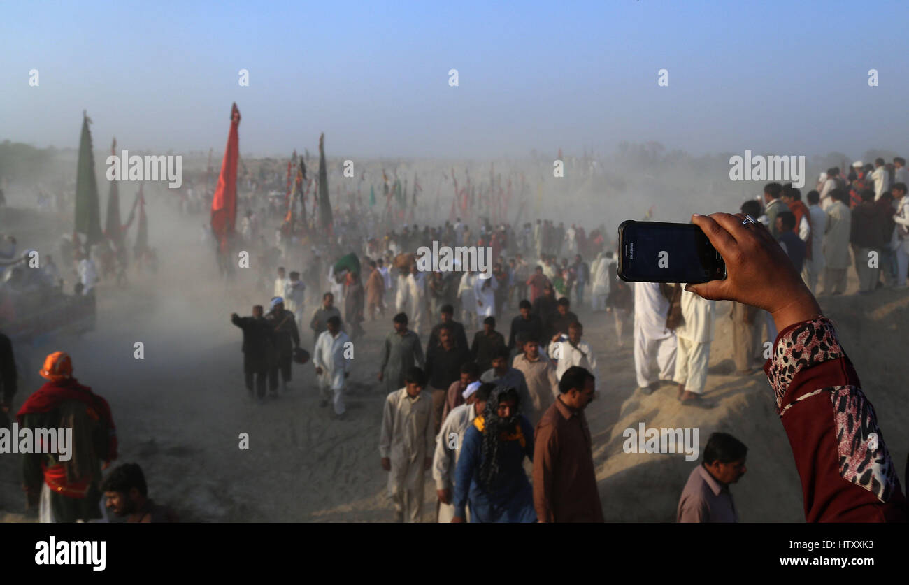 Hindu devotees carrying flags on their journey to the shrine of the ...