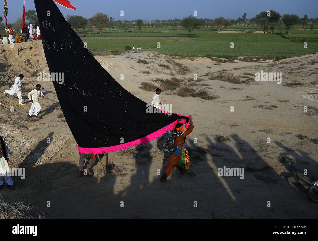 Hindu devotees carrying flags on their journey to the shrine of the ...