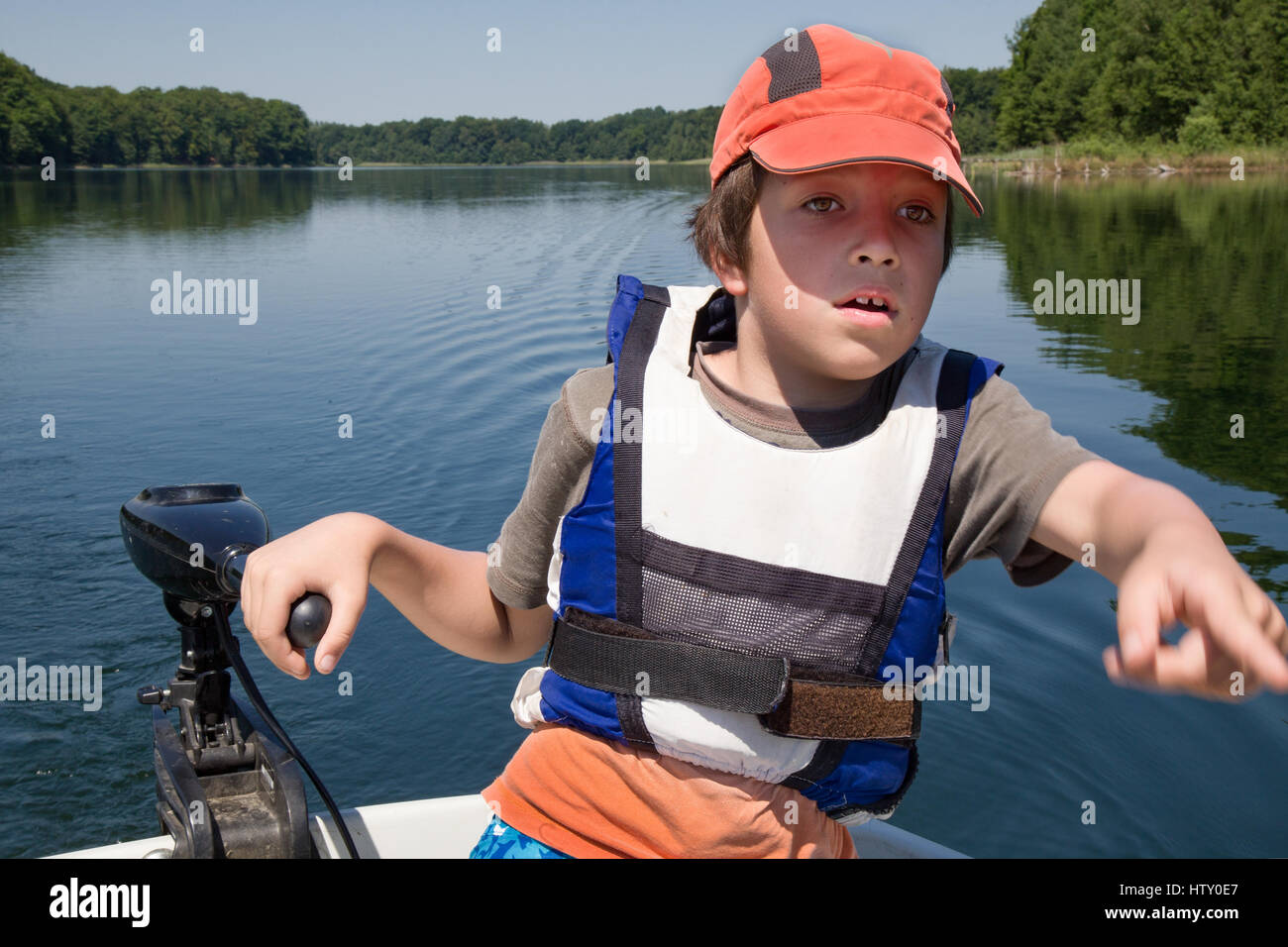 Kid driving boat hi-res stock photography and images - Alamy