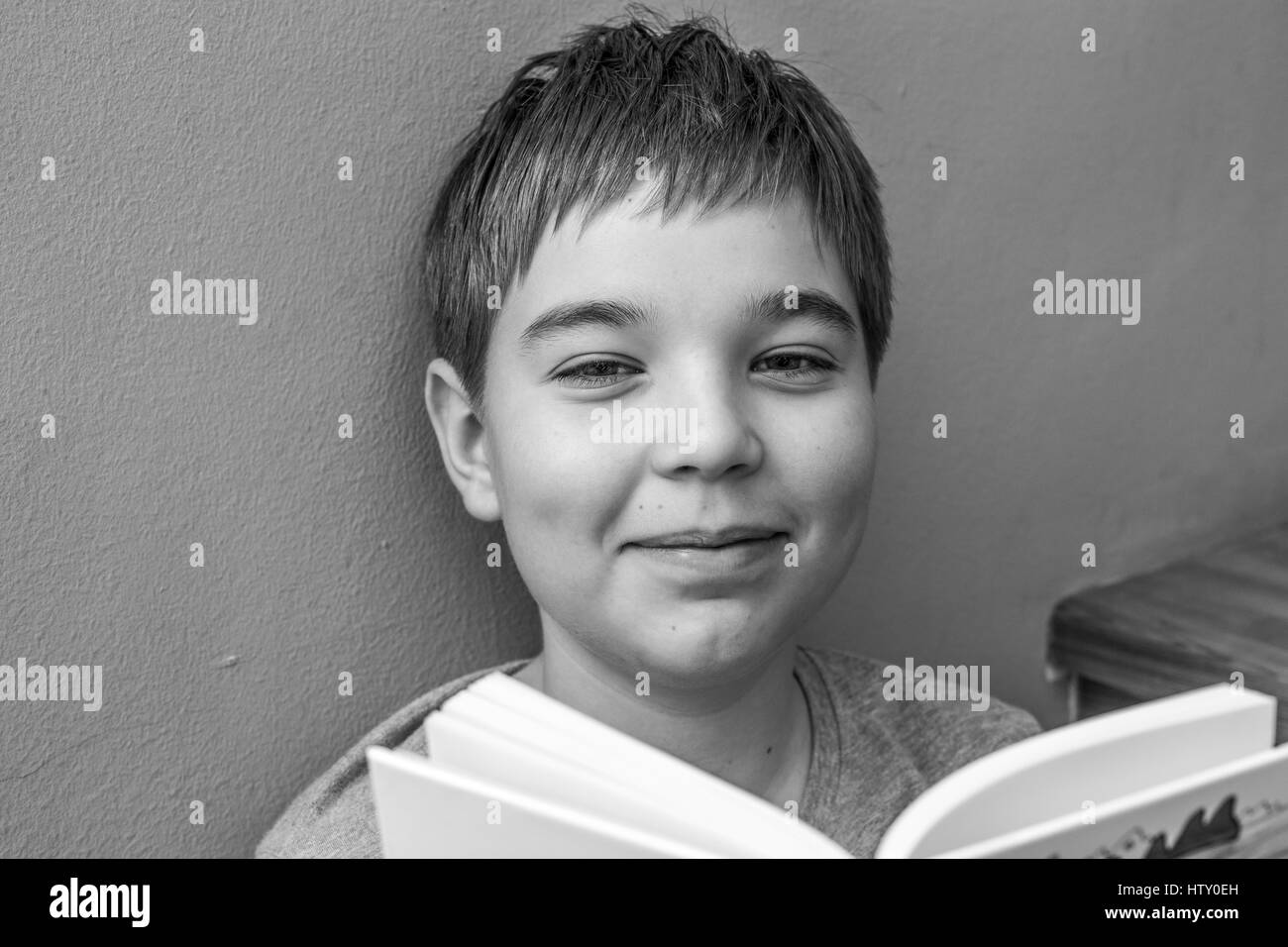 Boy smiling over his book, boy reading, black and white portrait Stock ...