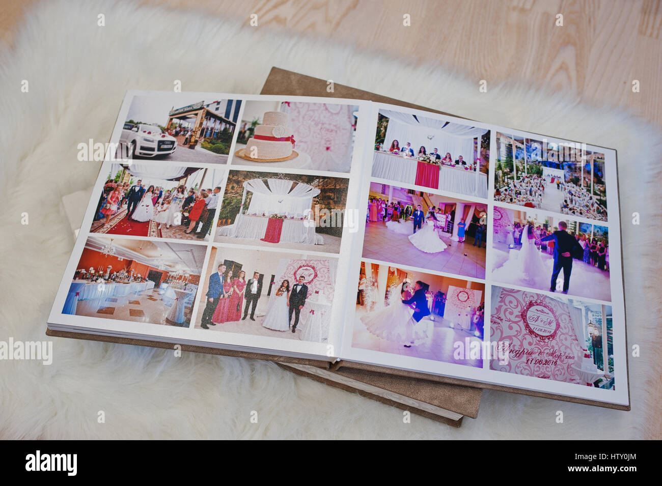 Pages of wedding photobook or wedding album at carpet on wooden ...