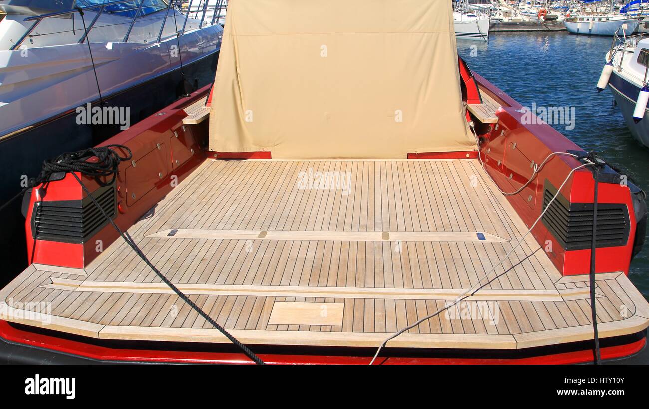 Modern red motor boat from rear with wide wooden deck and canvas Stock ...