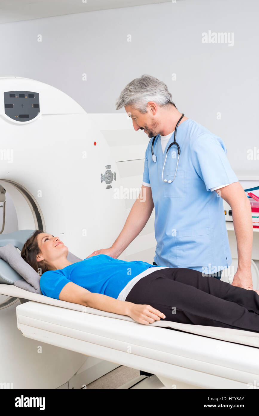 Doctor Talking To Patient Lying On CT Scan Machine Stock Photo - Alamy